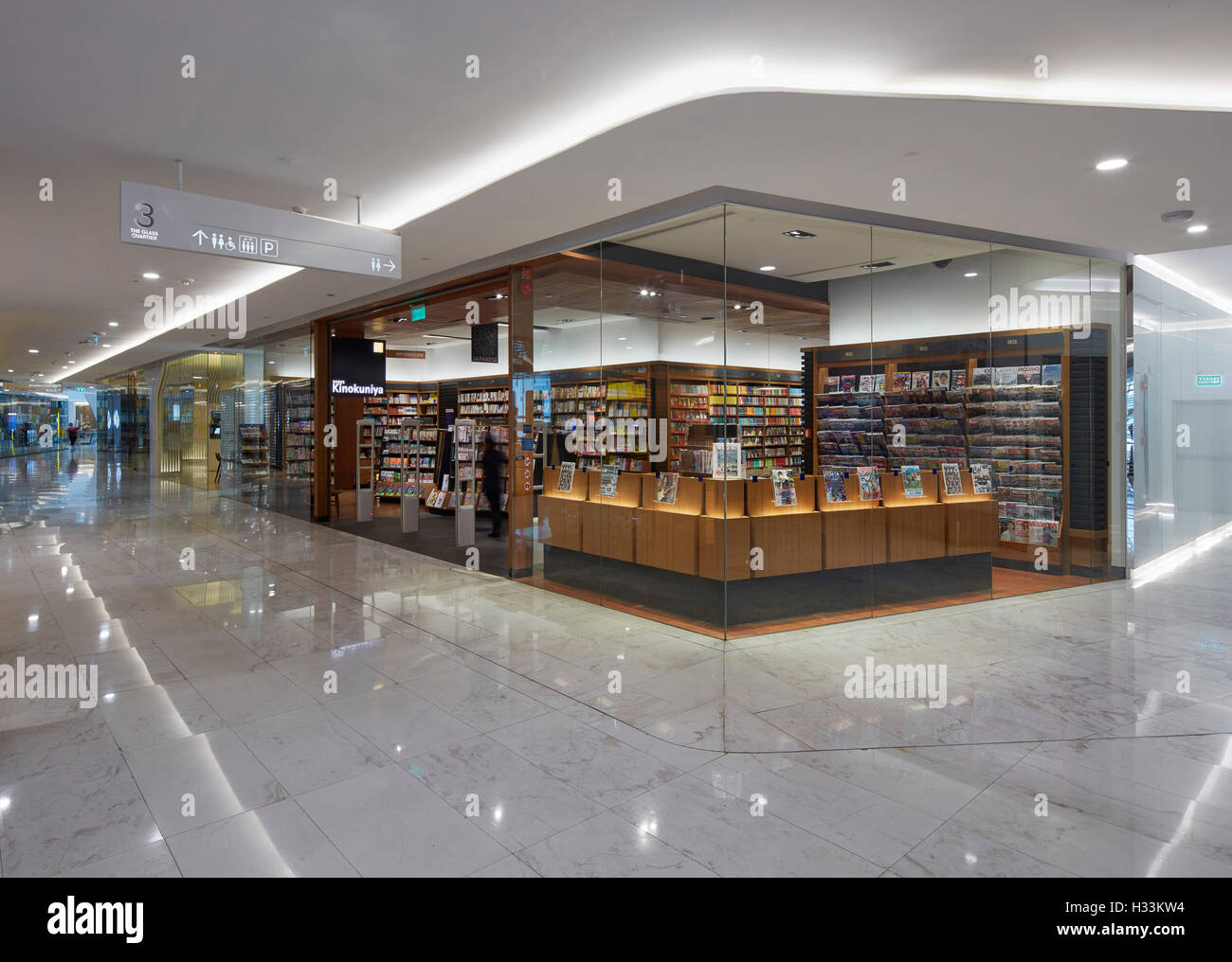 Corner elevation of glazed bookstore interior. Kinokuniya EmQuartier ...