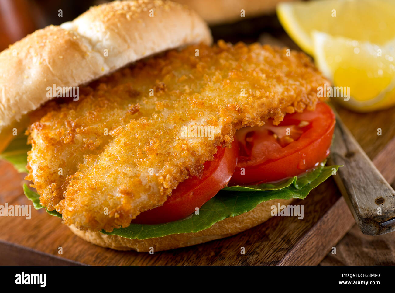 A delicious homemade fish burger with lettuce and tomato on a bun Stock ...