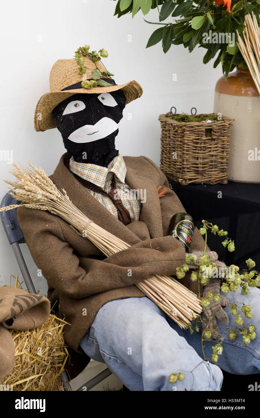Farmer scarecrow sitting down with his crops Stock Photo - Alamy