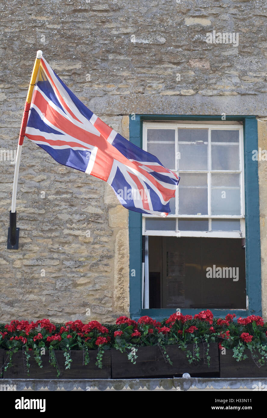 open window and the union jack flying in the cotswolds England Stock ...