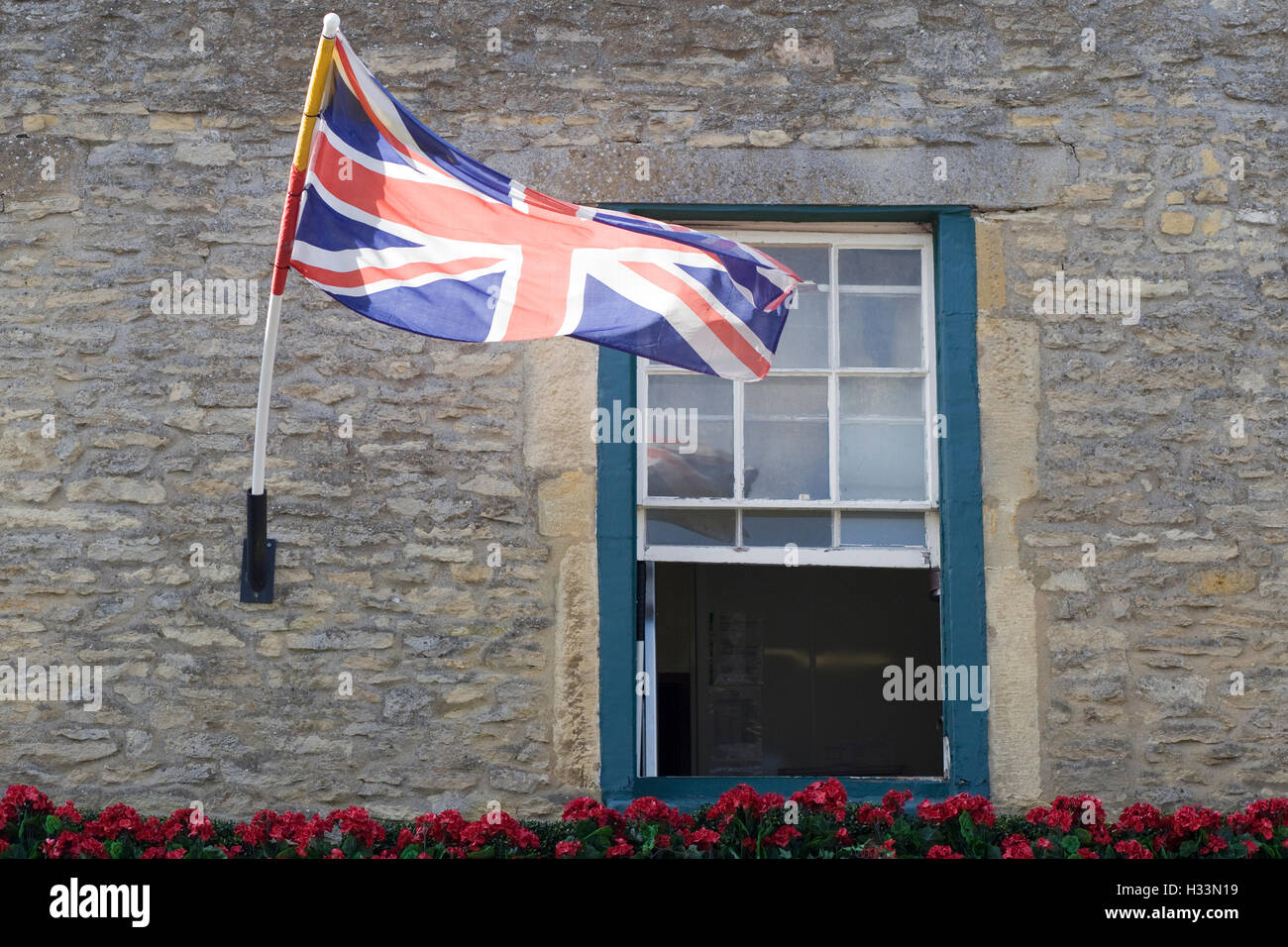 open window and the union jack flying in the cotswolds England Stock ...