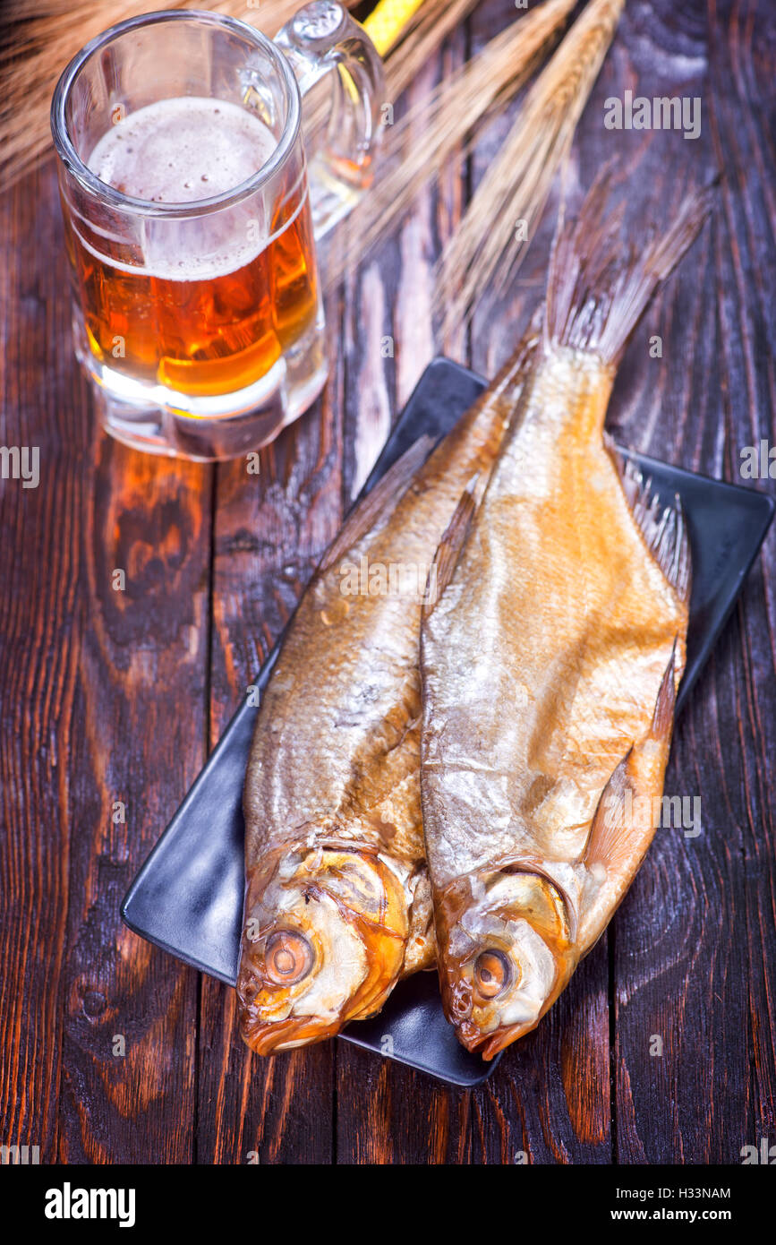 smoked fish on plate and on a table Stock Photo - Alamy