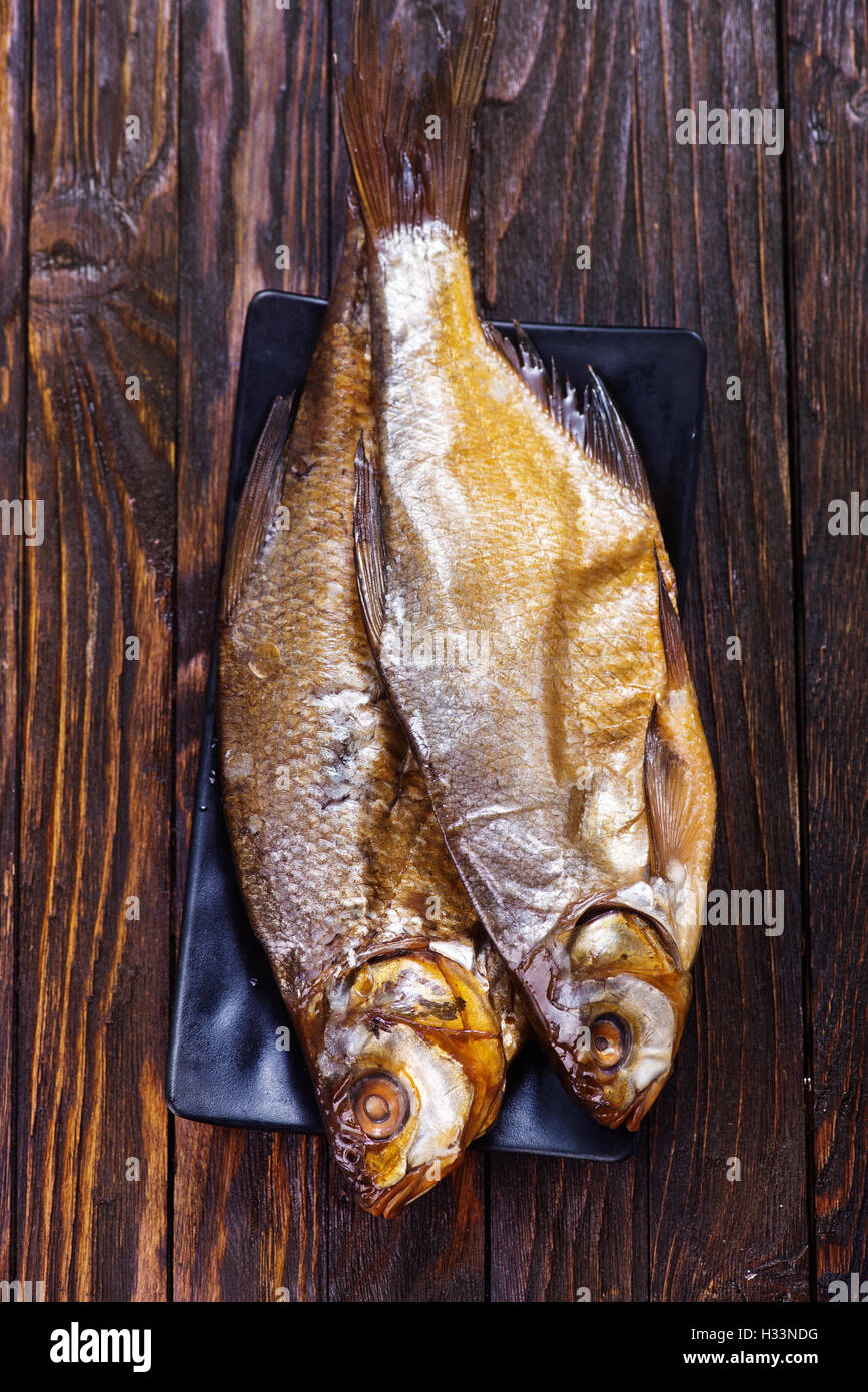 smoked fish on plate and on a table Stock Photo - Alamy