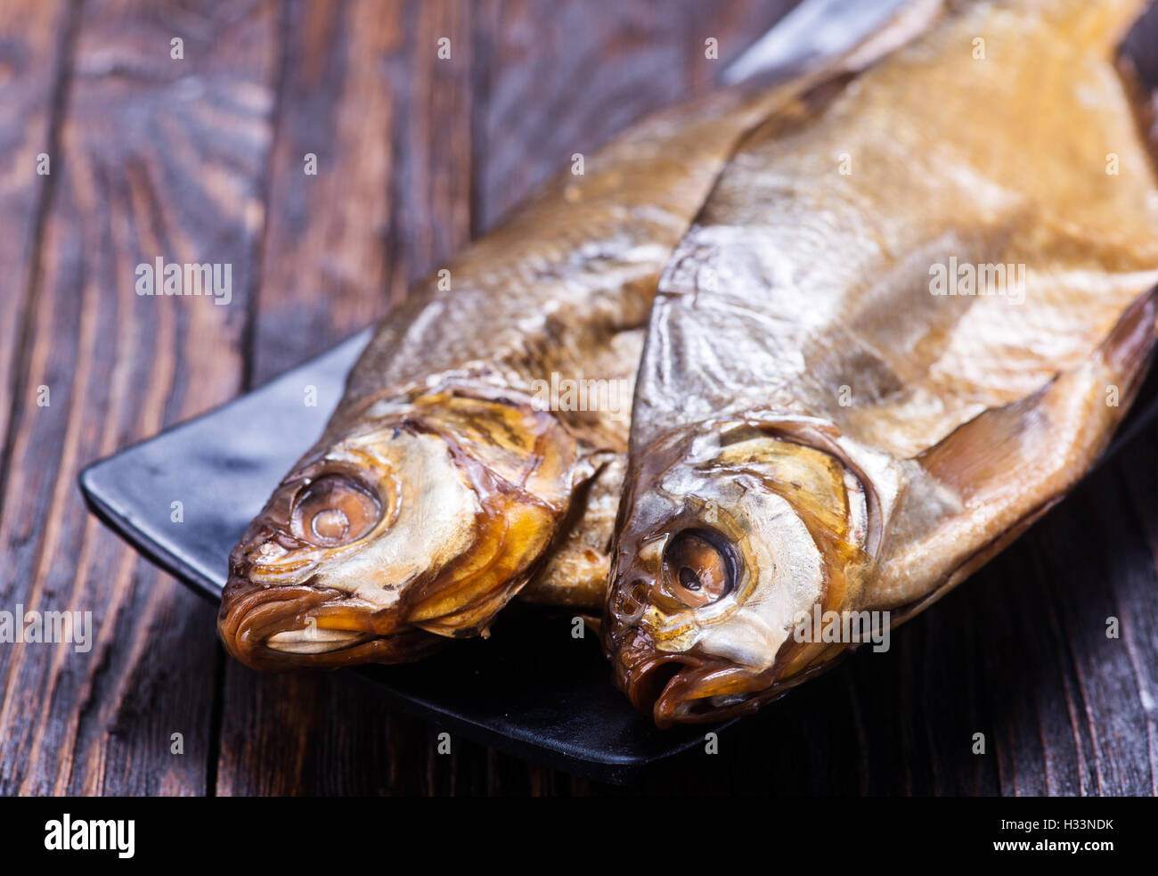 smoked fish on plate and on a table Stock Photo - Alamy