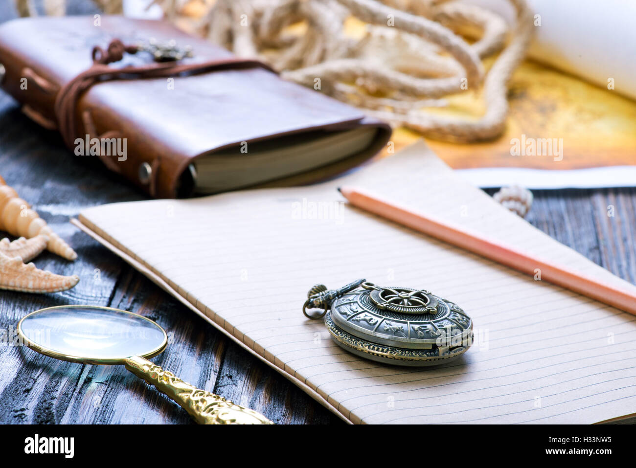 Travel items on wooden table, notebook and shells Stock Photo - Alamy