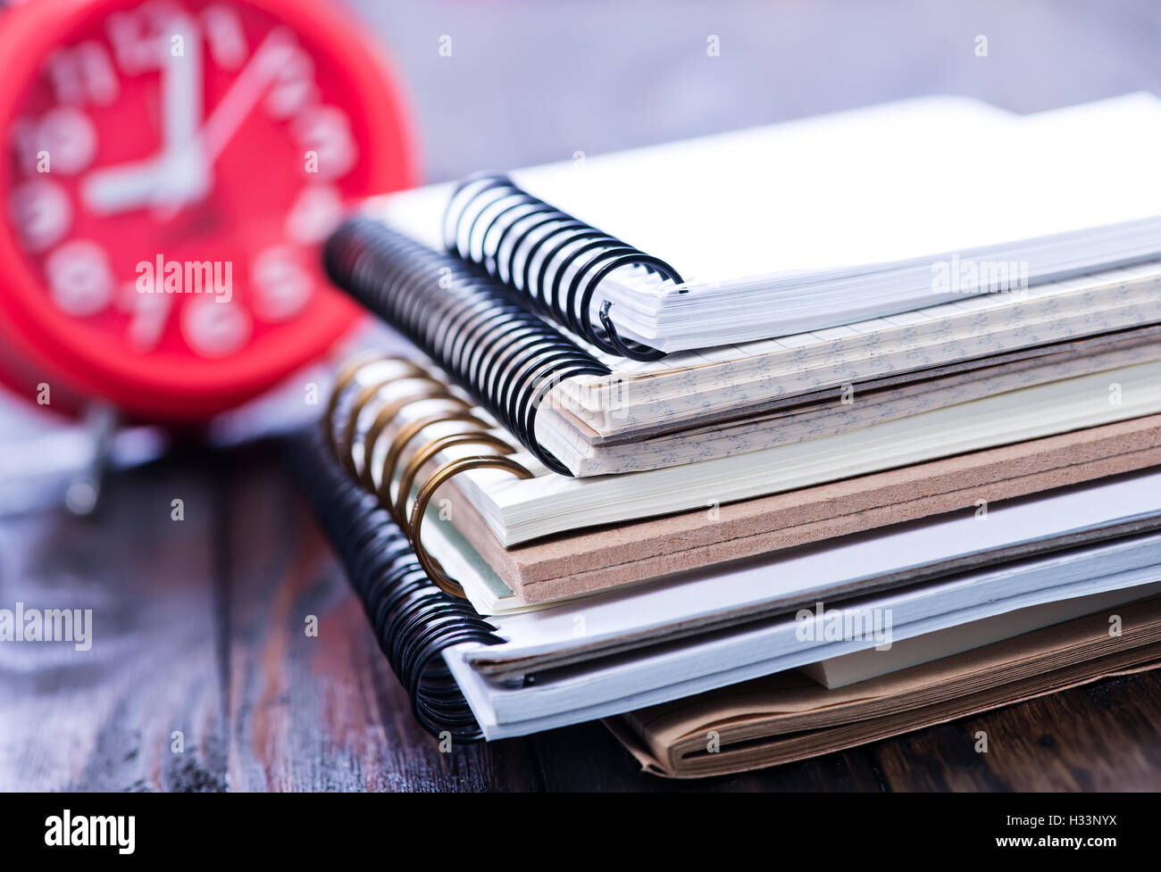 Stack of spiral notebooks on a table Stock Photo - Alamy