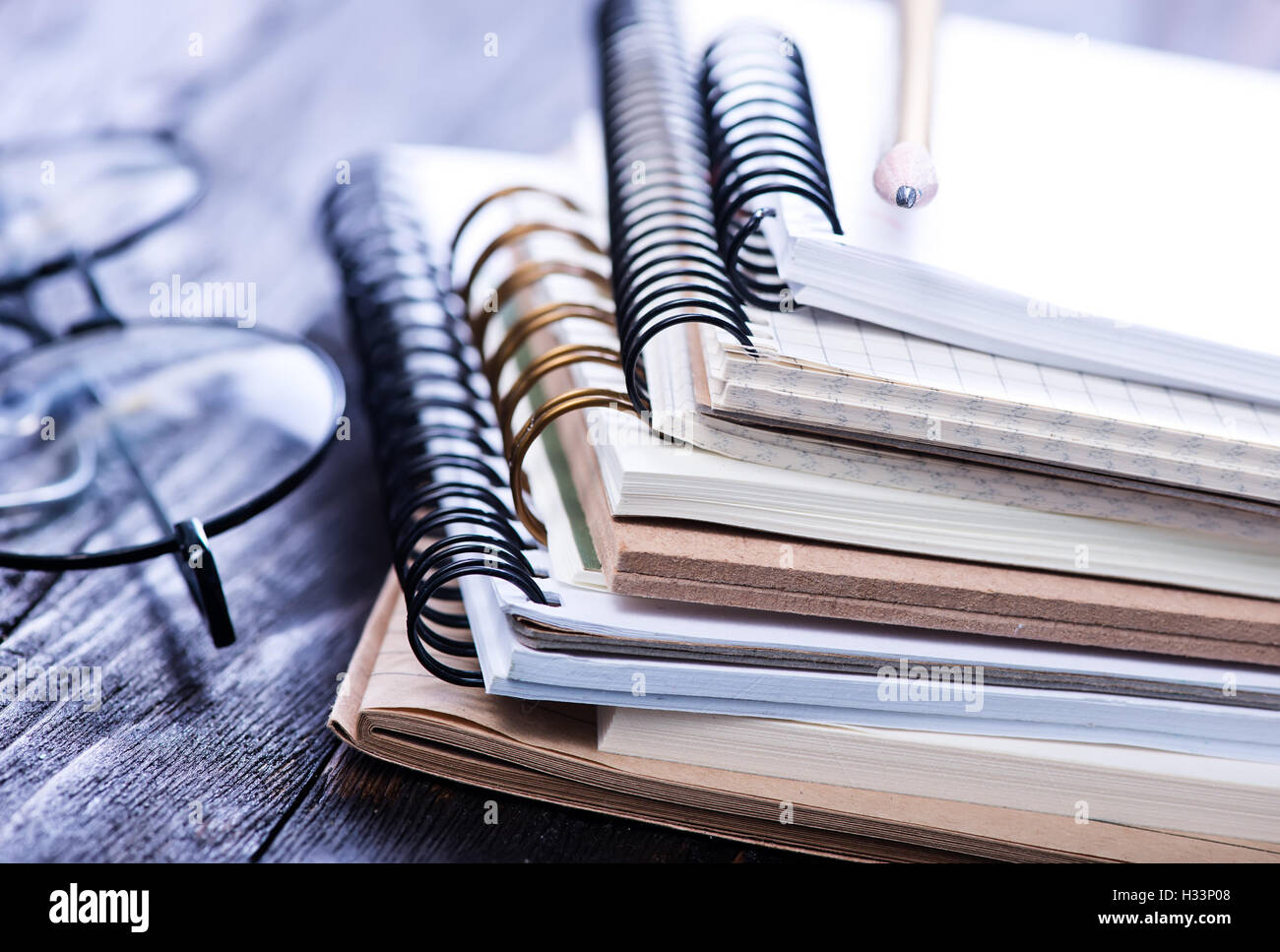 Stack of spiral notebooks on a table Stock Photo - Alamy