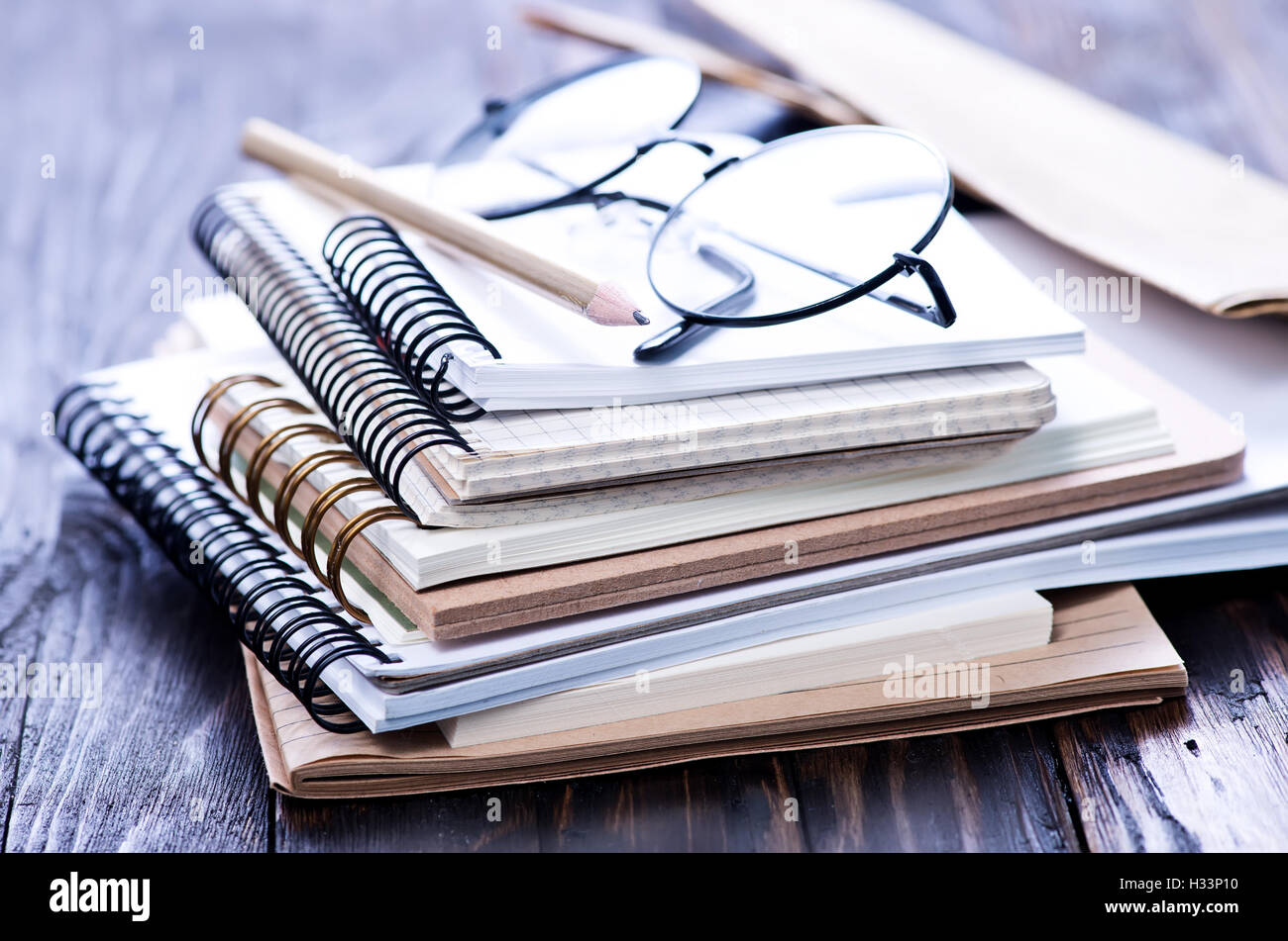 Stack of spiral notebooks on a table Stock Photo - Alamy