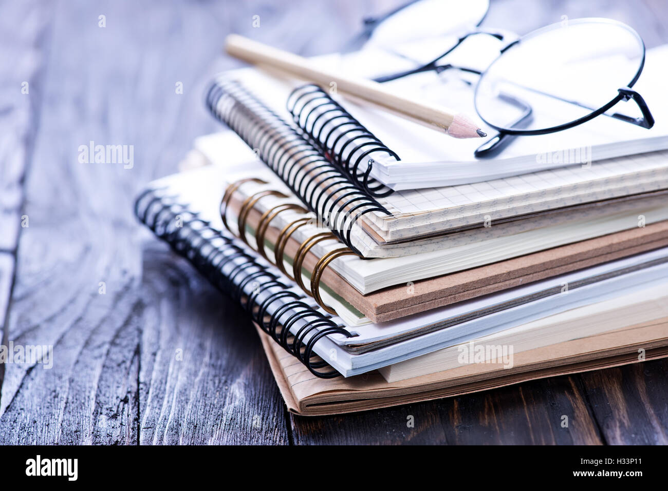 Stack of spiral notebooks on a table Stock Photo - Alamy