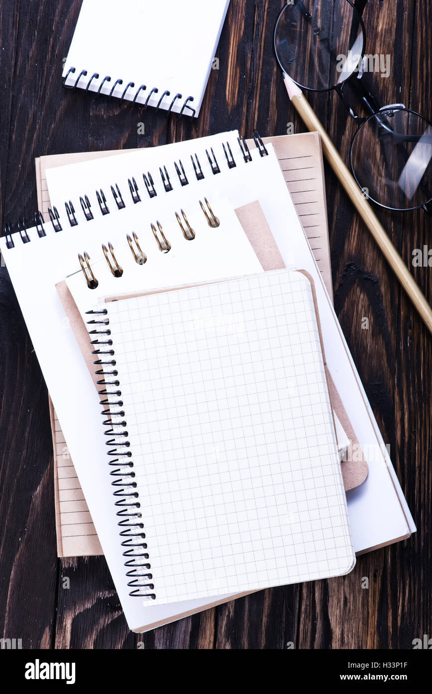 Stack of spiral notebooks on a table Stock Photo - Alamy