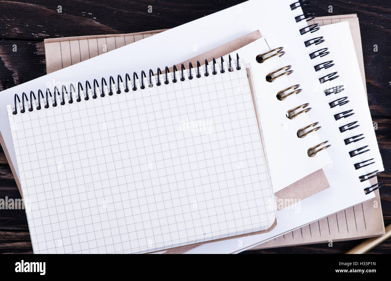 Stack of spiral notebooks on a table Stock Photo - Alamy