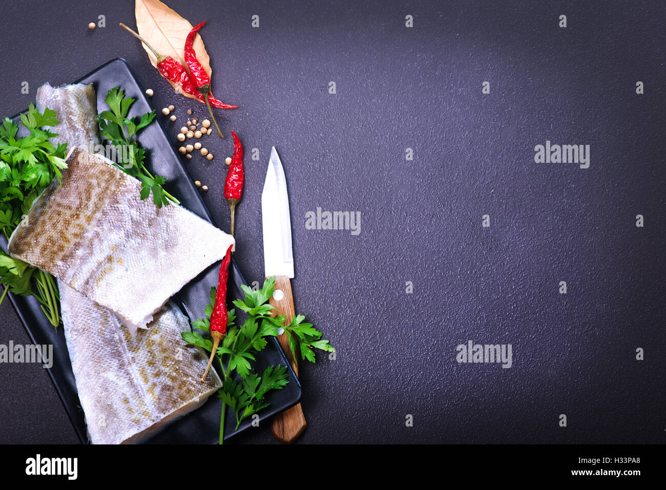 raw fish fillet and aroma spice on a table Stock Photo - Alamy