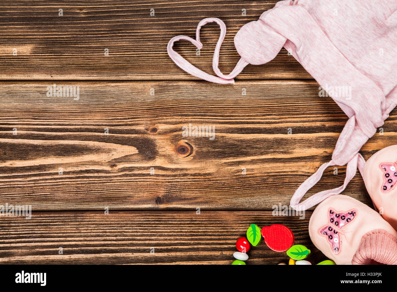 Baby clothes on wooden background Stock Photo - Alamy