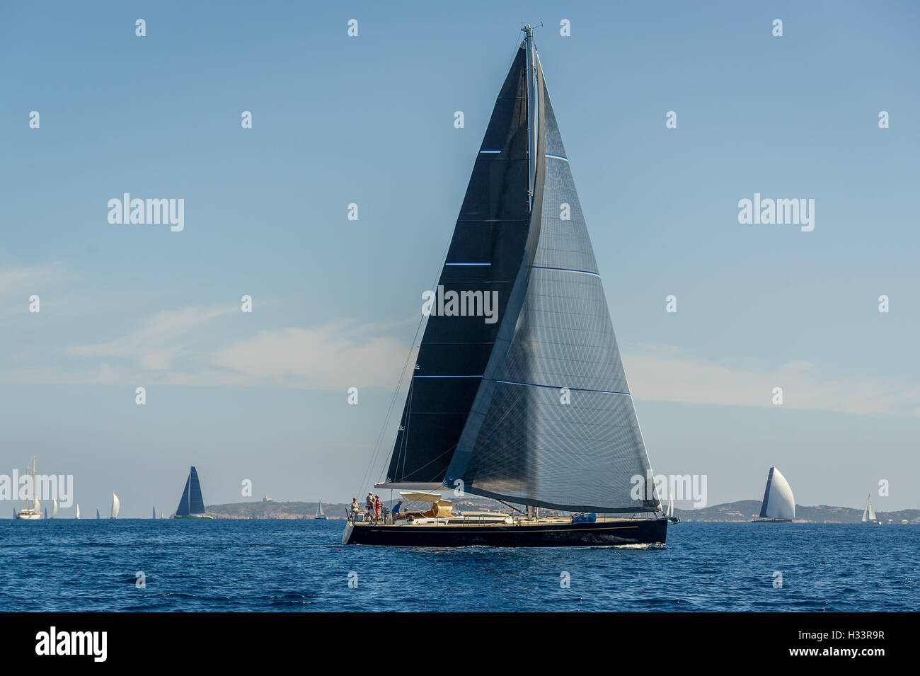 Luxury big sailing yacht with black sails Stock Photo - Alamy