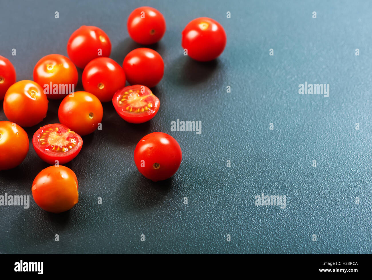 raw tomato cherry on the black table Stock Photo - Alamy
