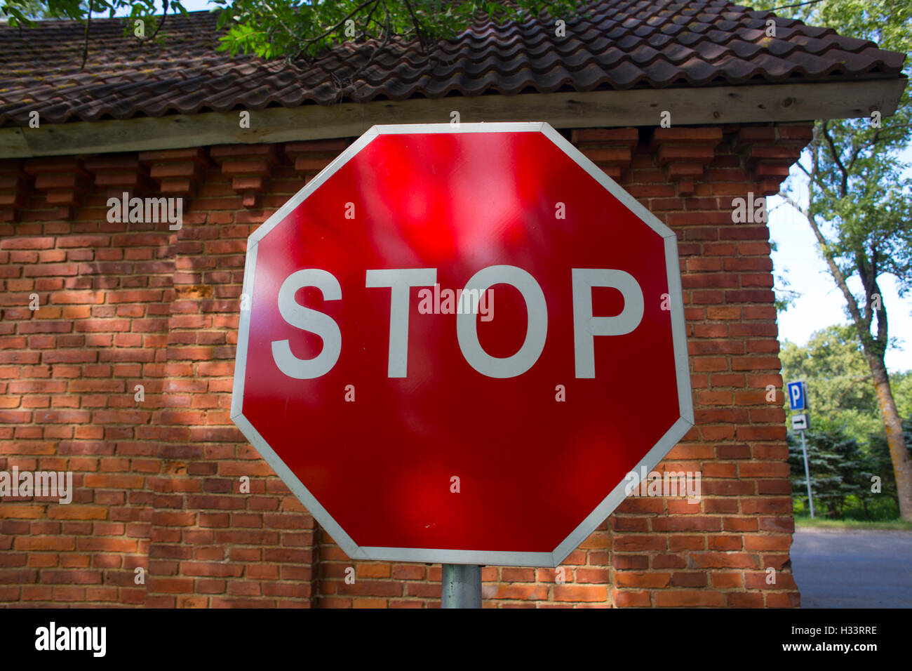 Stop sign in front of brick wall Stock Photo - Alamy