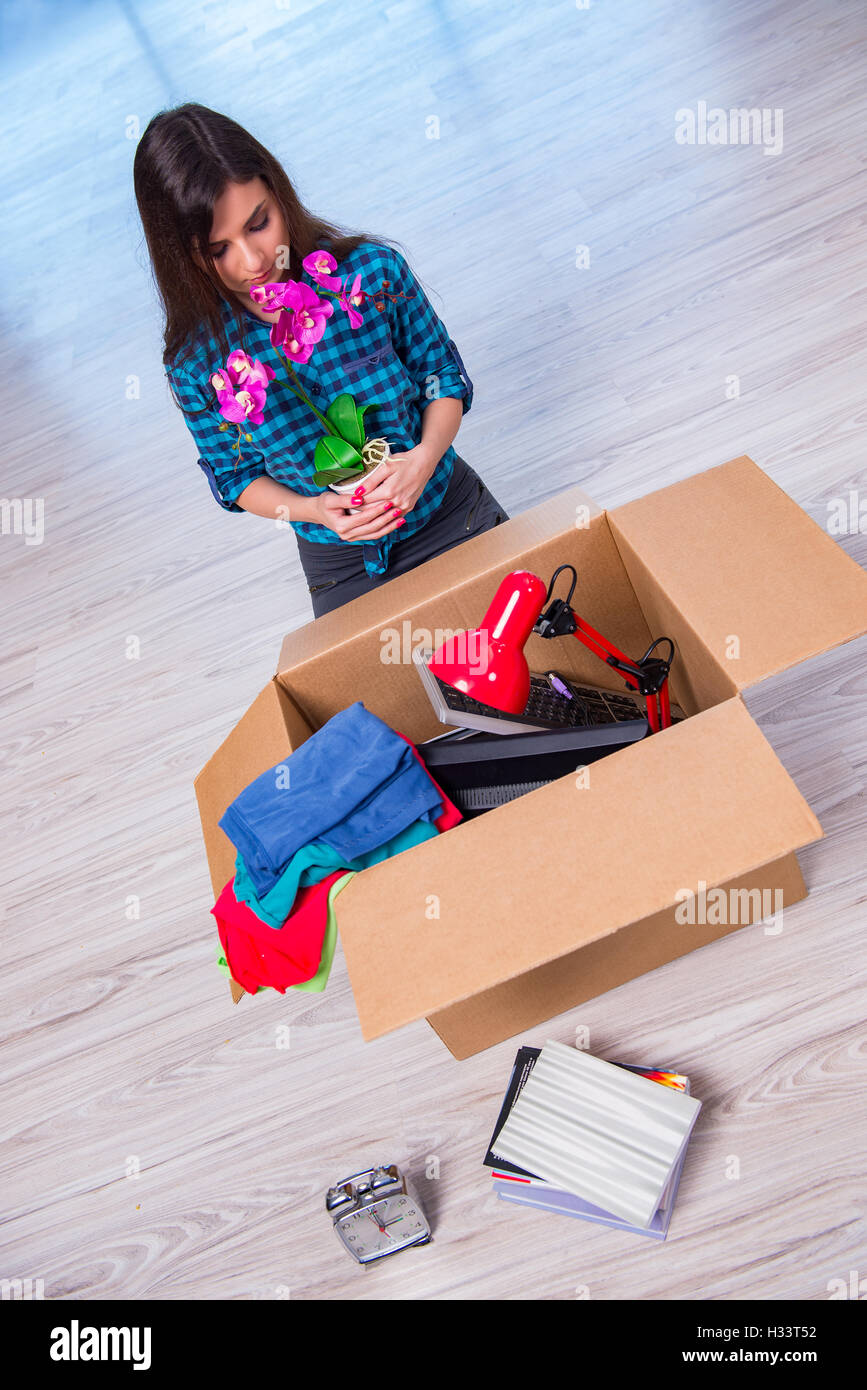 Young woman moving personal belongings Stock Photo - Alamy