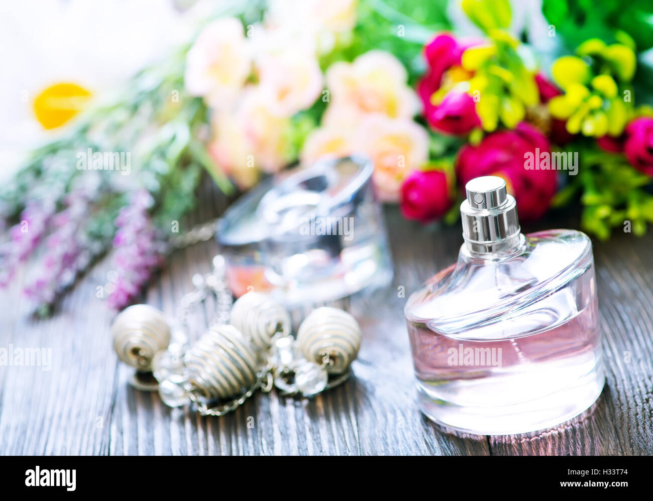 perfume and flowers on the wooden table Stock Photo - Alamy