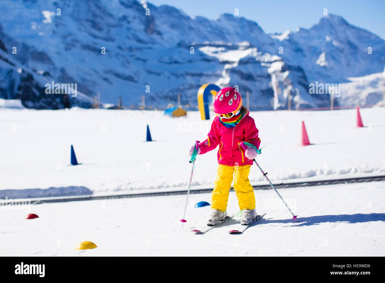 Child skiing in mountains. Active toddler kid with safety helmet ...