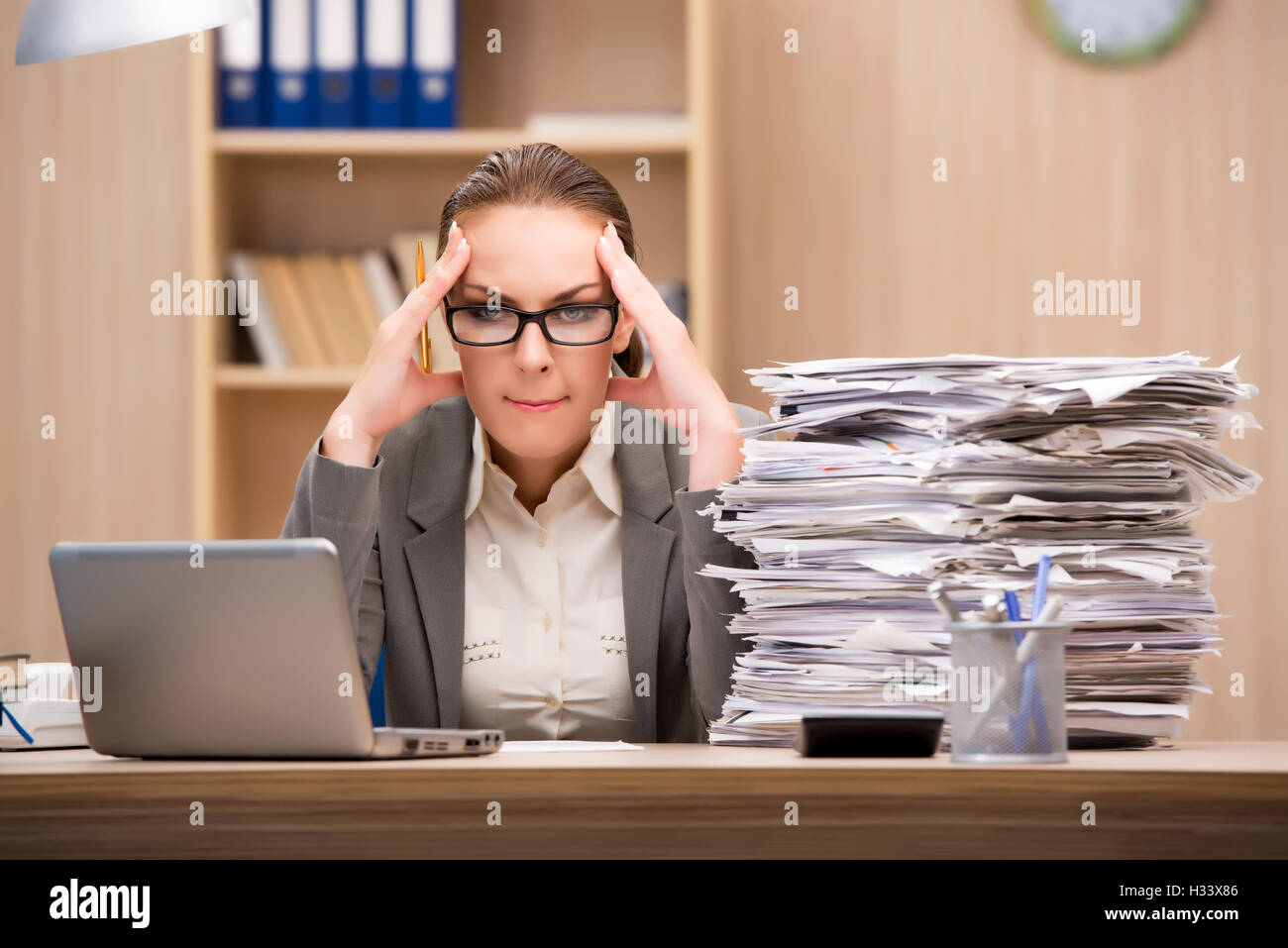 Businesswoman under stress from too much work in the office Stock Photo ...