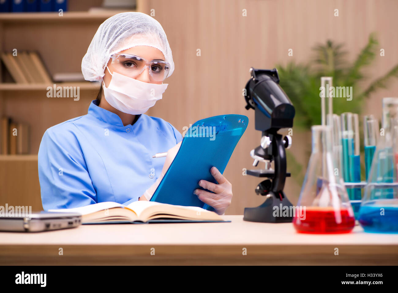 Lab chemist working with microscope and tubes Stock Photo - Alamy