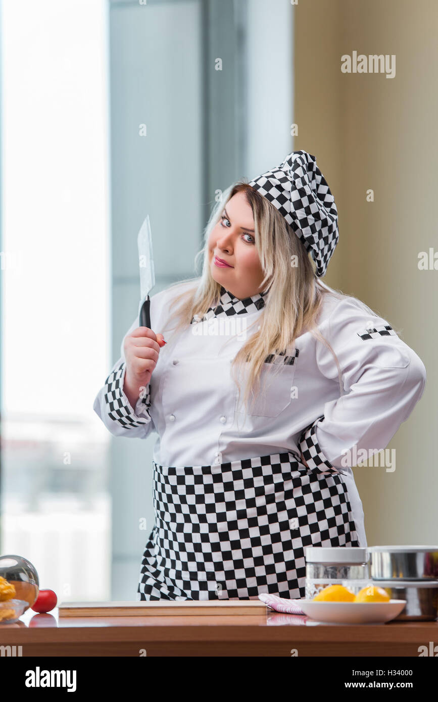 Young chef cook working in the kitchen Stock Photo - Alamy