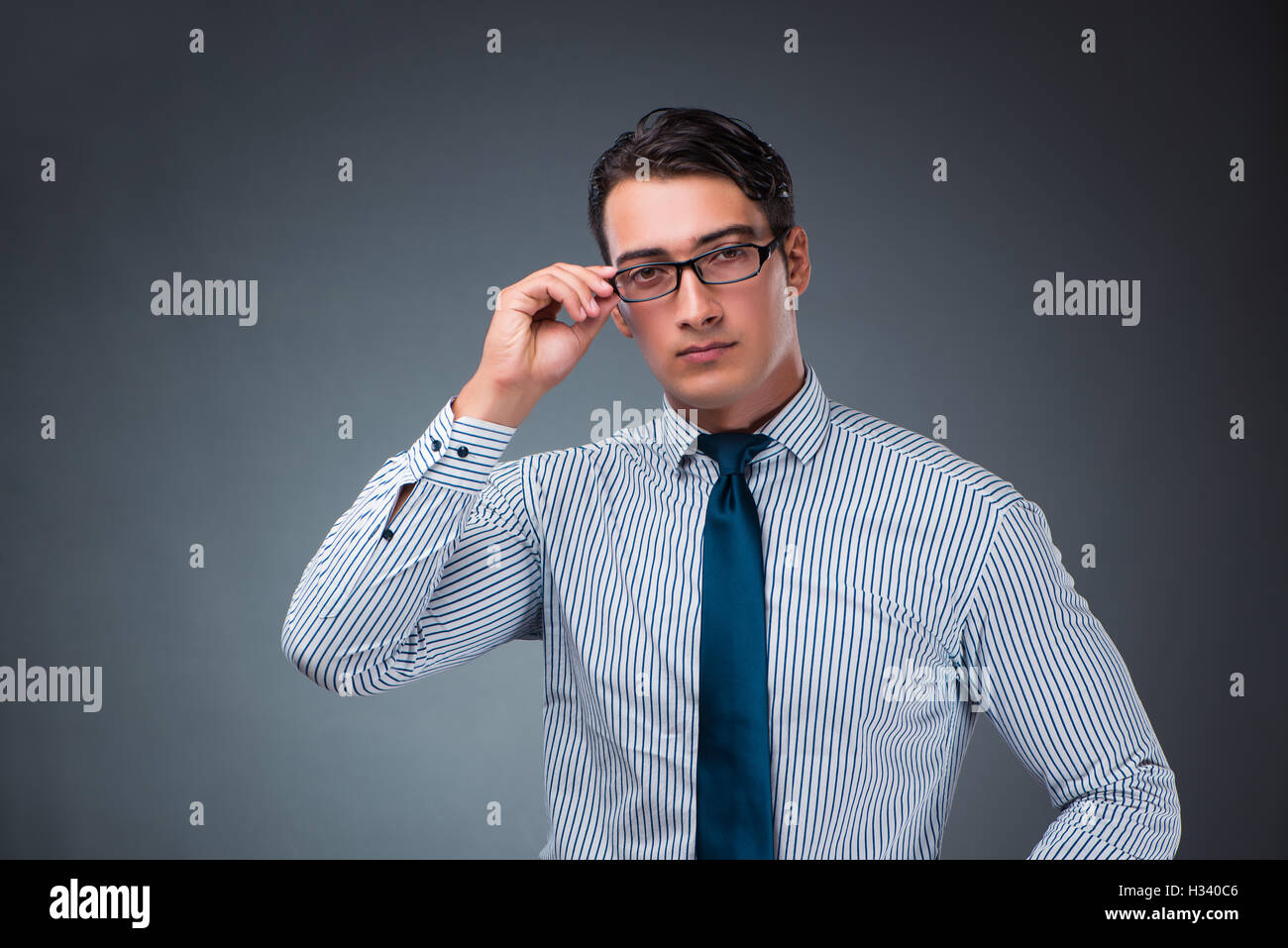 Handsome businessman against gray background Stock Photo - Alamy