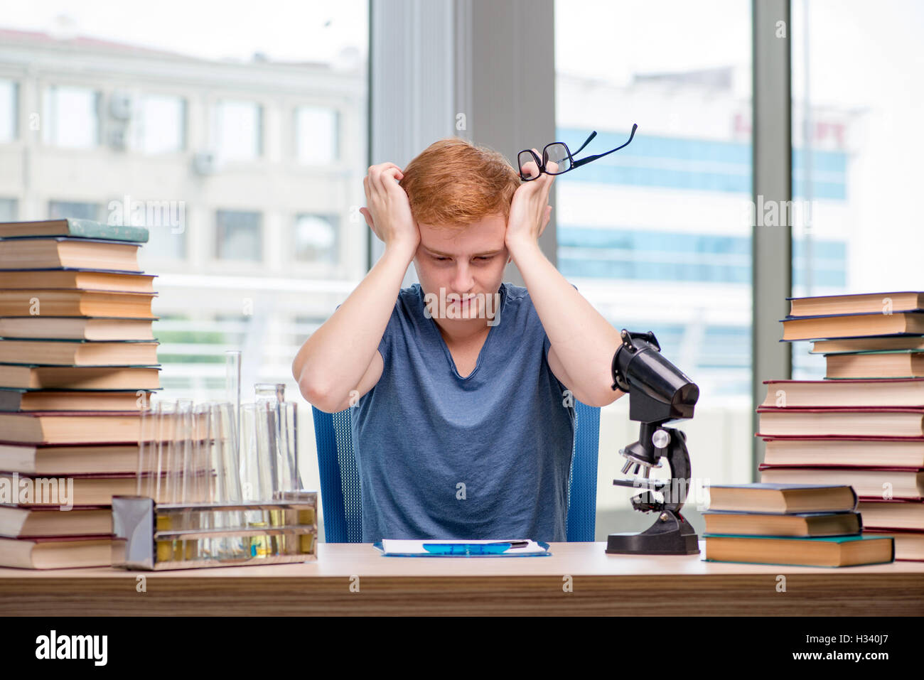 Young student tired and exhausted preparing for chemistry exam Stock ...