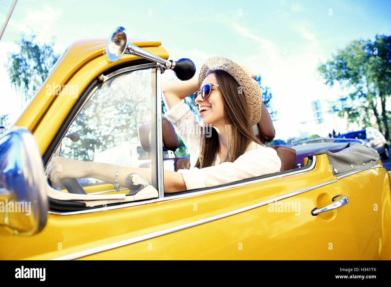 Portrait of Young girl driving cabriolet at sunset Stock Photo - Alamy