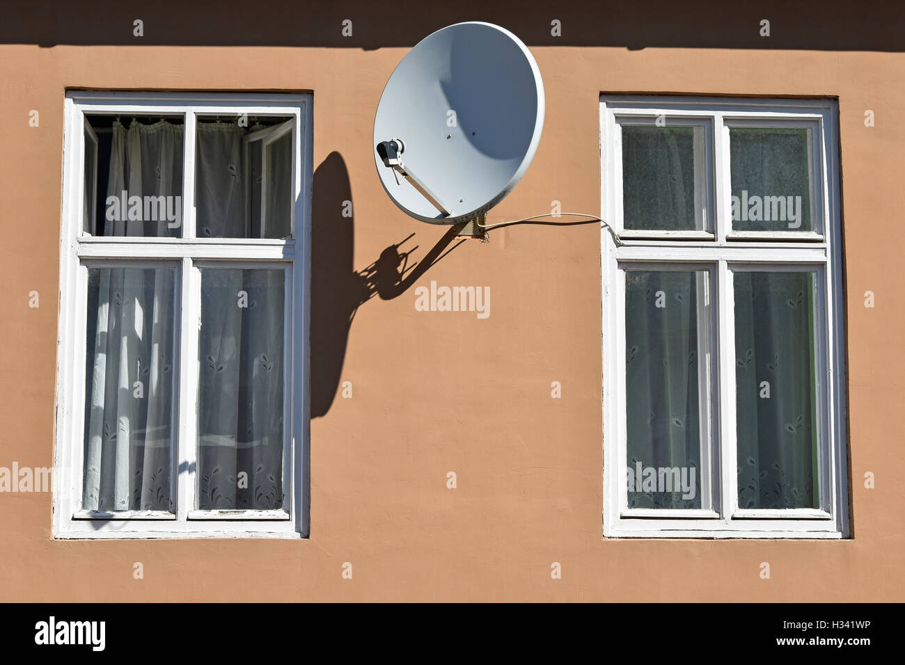 Windows and satellite dish on the wall Stock Photo - Alamy