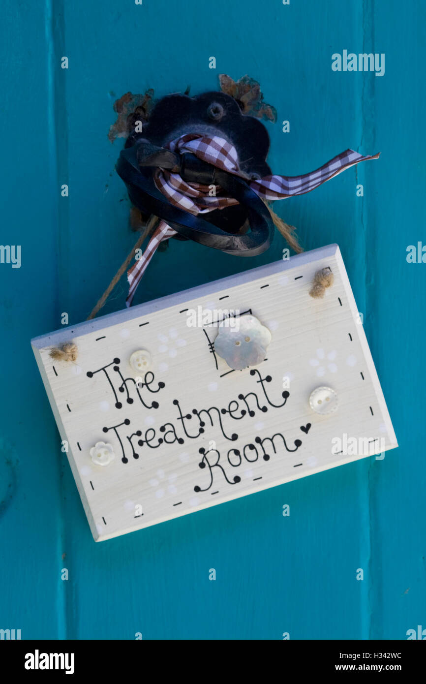 The treatment room sign on a front door to a surgery Stock Photo - Alamy