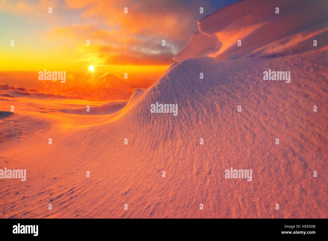 Fantastic orange evening landscape glowing by sunlight. Dramatic wintry ...
