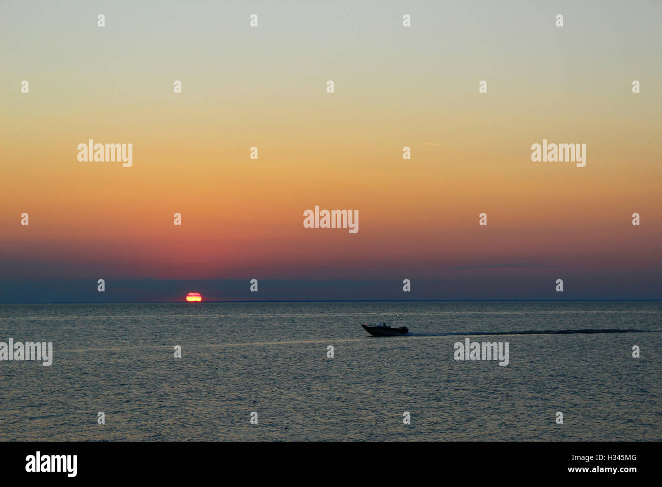 Boating at sunset Stock Photo - Alamy