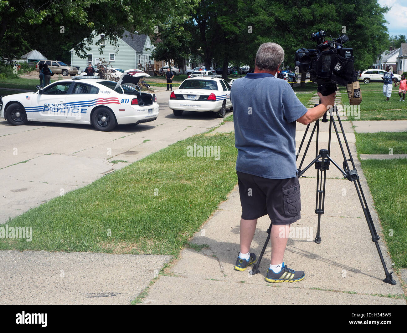 TV news cameraman at scene of a homicide in Detroit, Michigan, USA ...