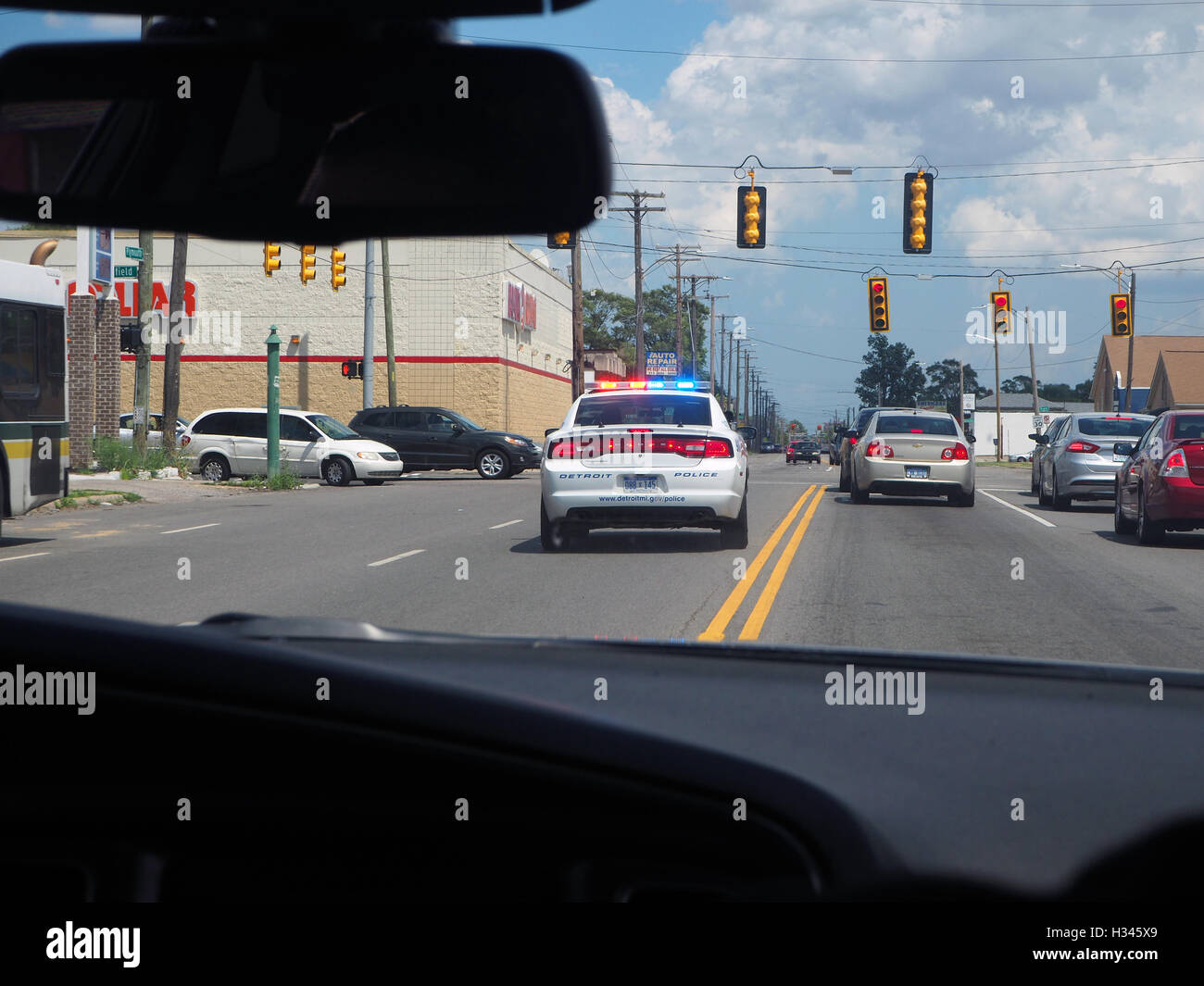 Detroit police cars rush through traffic in Detroit, Michigan, USA ...
