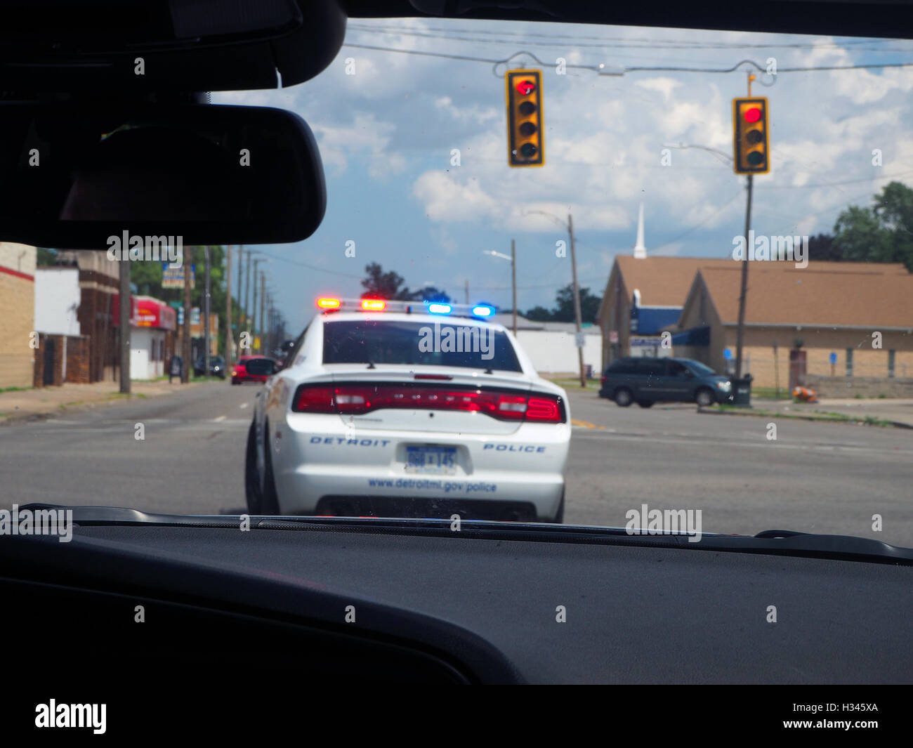 Detroit police cars rush through traffic in Detroit, Michigan, USA ...