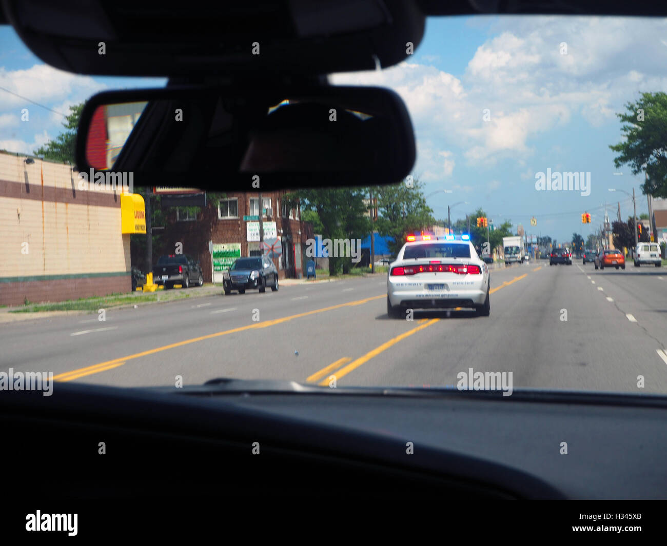 Detroit police cars rush through traffic in Detroit, Michigan, USA ...