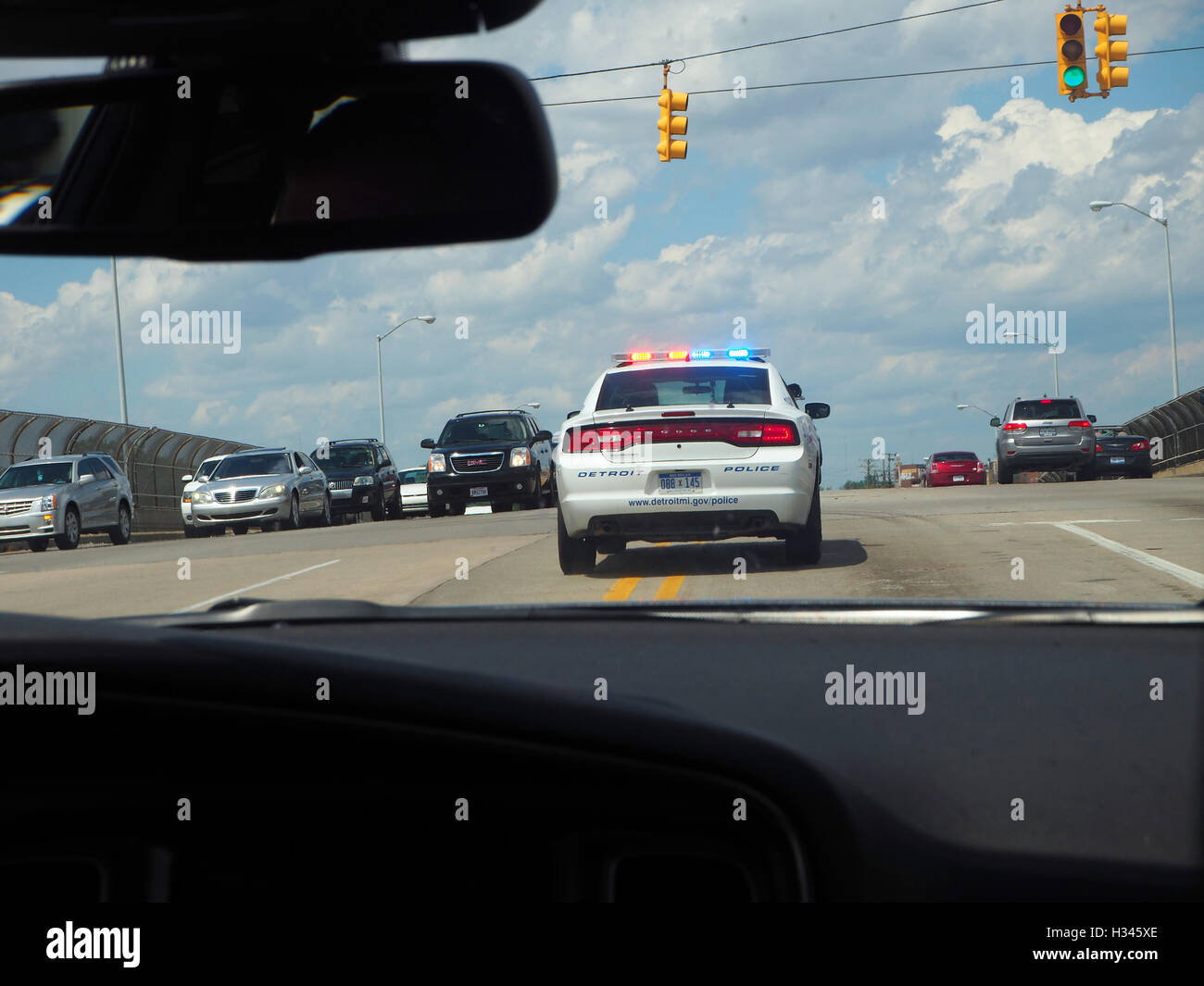 Detroit police cars rush through traffic in Detroit, Michigan, USA ...