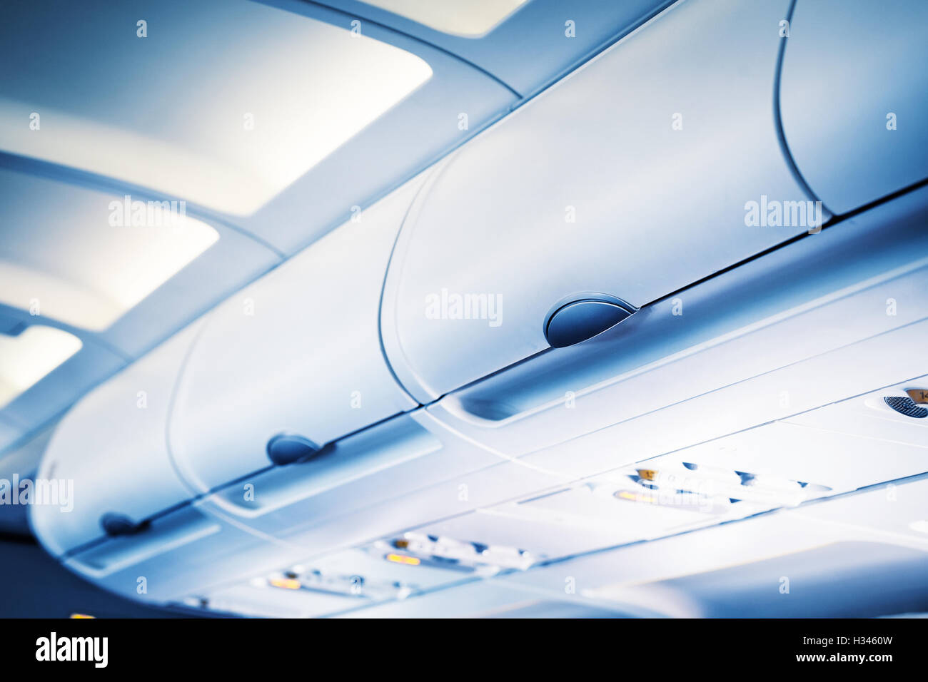 Luggage compartment of the aircraft toned in blue Stock Photo - Alamy
