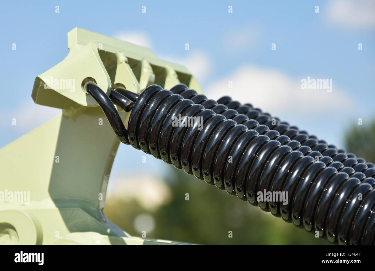Large springs of an agricultural machinery Stock Photo - Alamy
