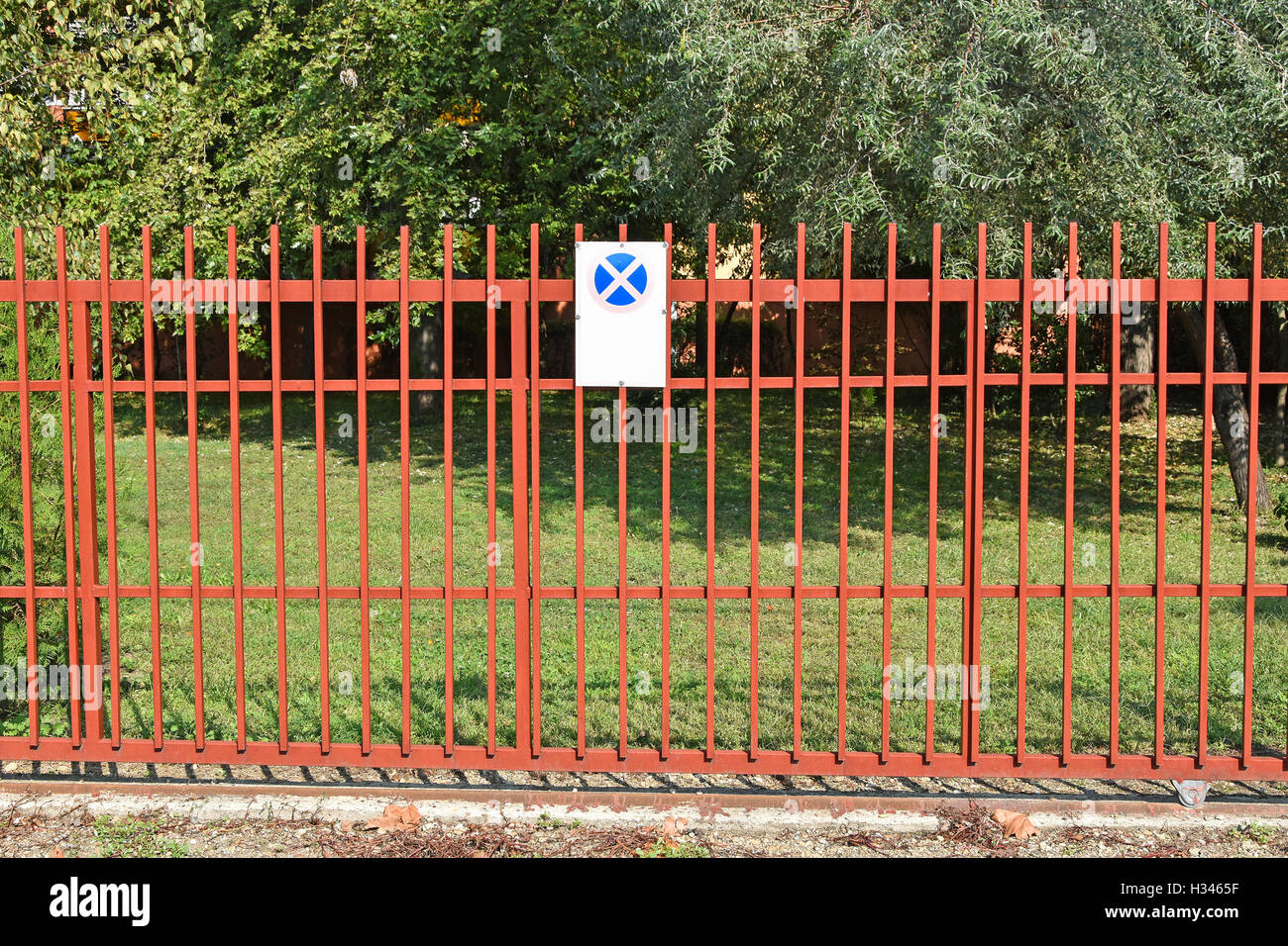 Closed metal fence next to a yard Stock Photo - Alamy