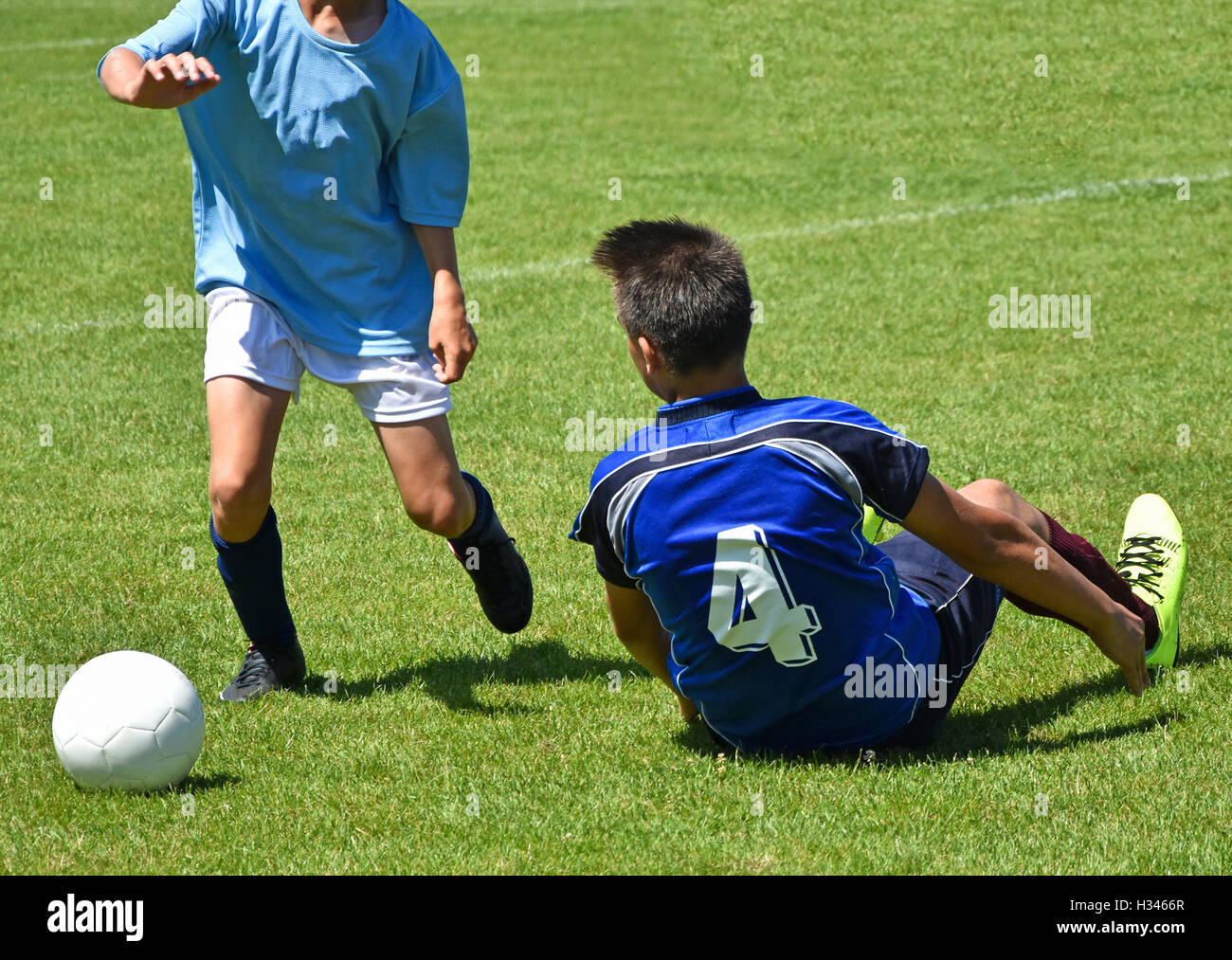 Young soccer players in action outdoors Stock Photo - Alamy