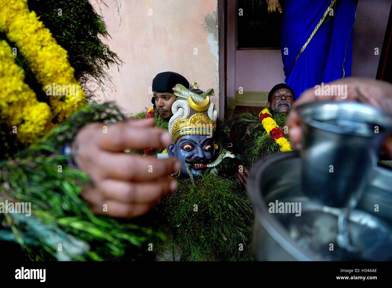 A Kummatti dancer takes a break during a procession in Thrissur, Kerala ...