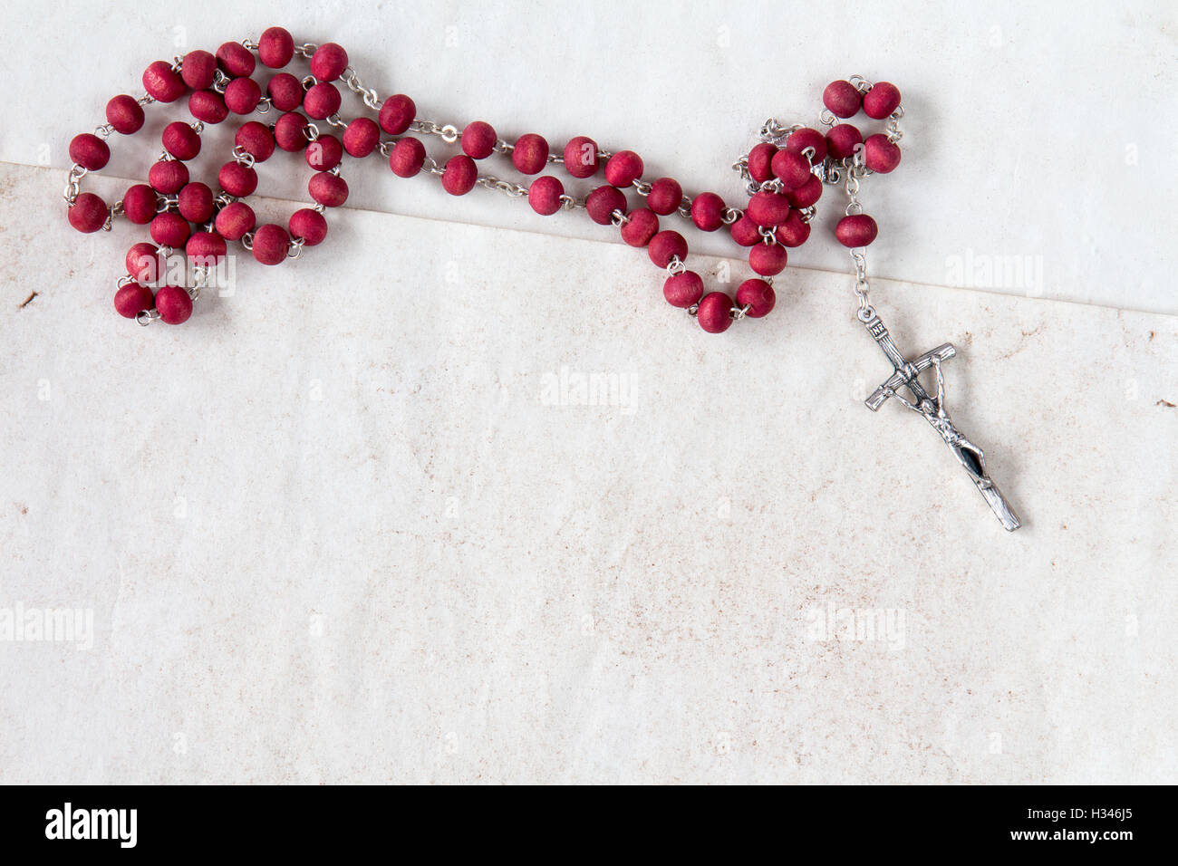 Catholic rosary on old paper sheets with copy-space Stock Photo - Alamy