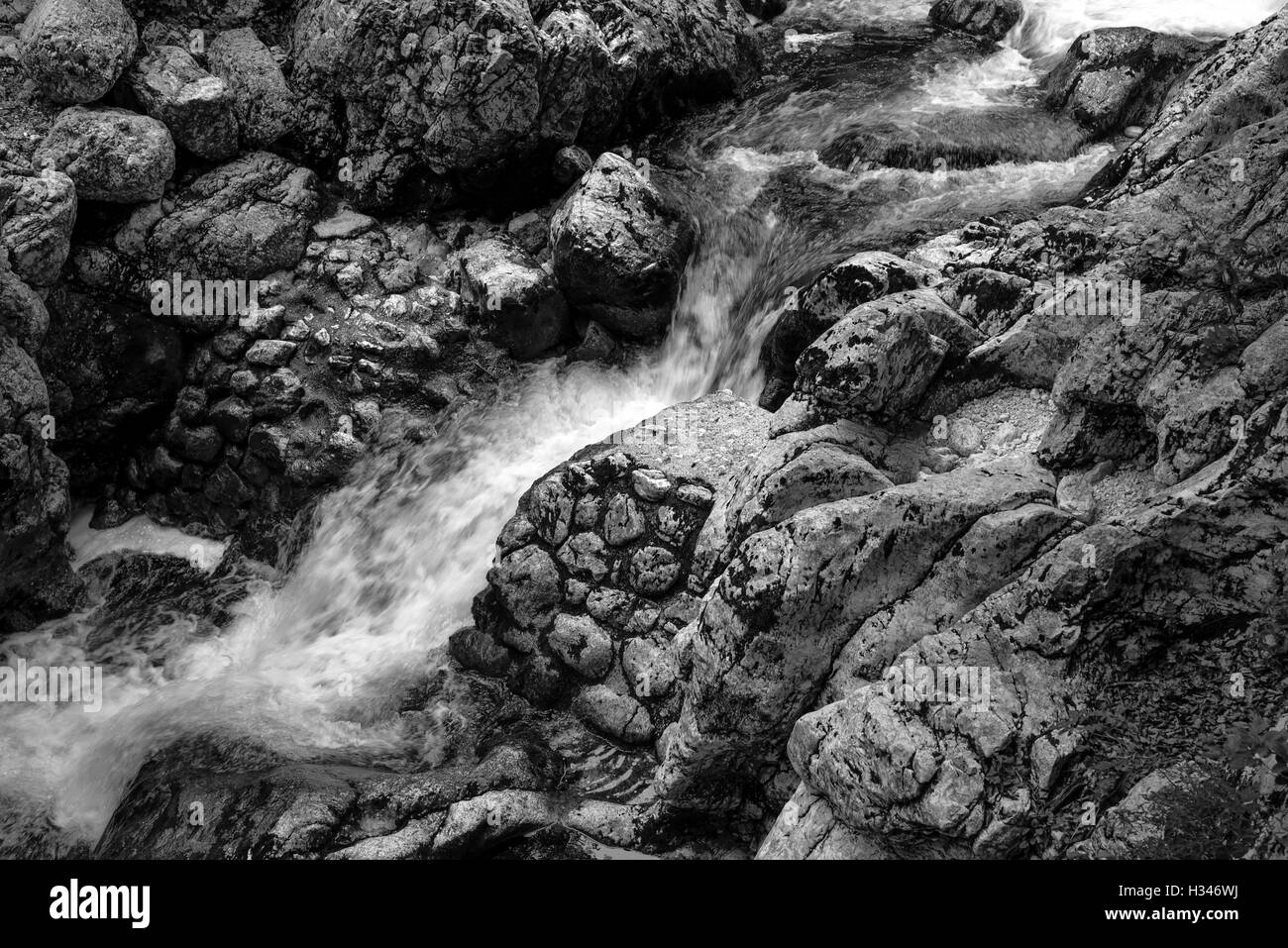 Mountain stream detail, cold freshwater running over rocks and stones ...