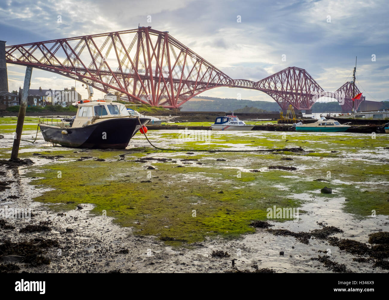 Boat moored in front of the Forth Rail Bridge in Edinburgh, Scotland ...