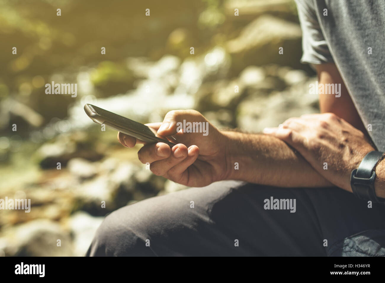 Male tourist using mobile smart phone for GPS navigation in outdoors ...
