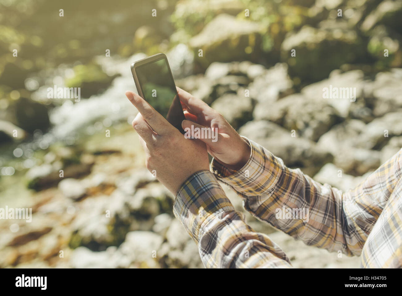 Female tourist using mobile smart phone for GPS navigation in outdoors ...