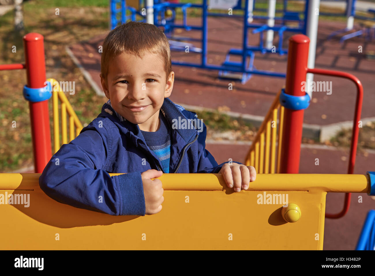 Portrait of a happy child on the playground Stock Photo - Alamy