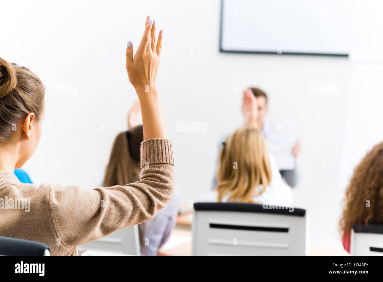 female hand raised in class Stock Photo - Alamy